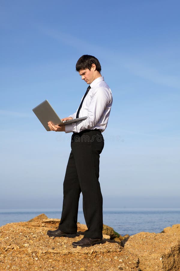 Businessman with laptop stock photo. Image of stones - 17960062