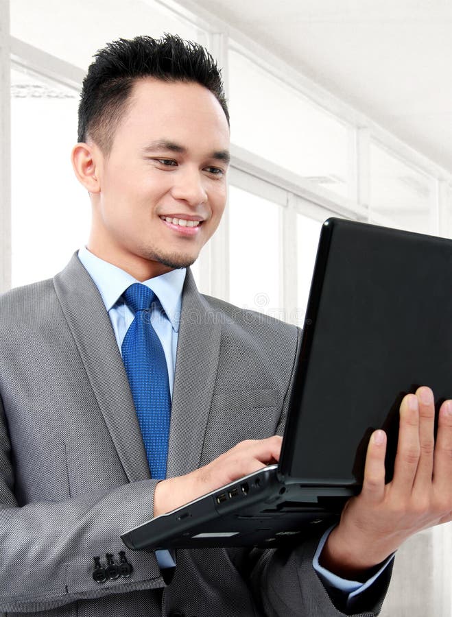 Businessman with laptop stock image. Image of office - 27751013