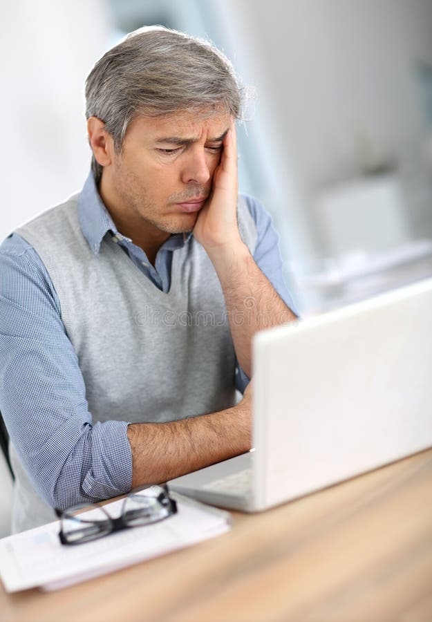 Businessman with Laptop Being Concerned Stock Photo - Image of sitting ...