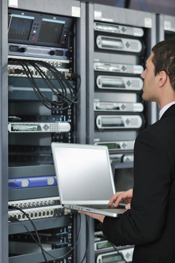 Businessman with Laptop in Network Server Room Stock Photo - Image of ...