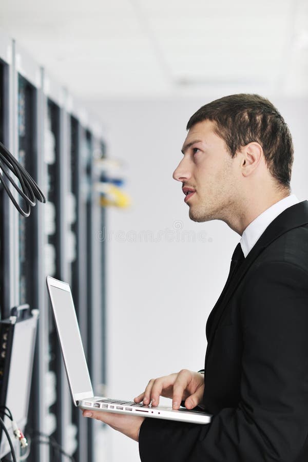 Businessman with Laptop in Network Server Room Stock Image - Image of ...