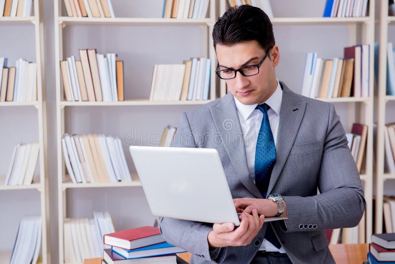 The Businessman with a Laptop Working in the Library Stock Photo ...