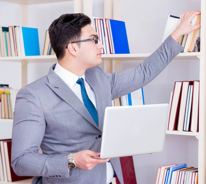 Businessman with a Laptop Working in the Library Stock Photo - Image of ...