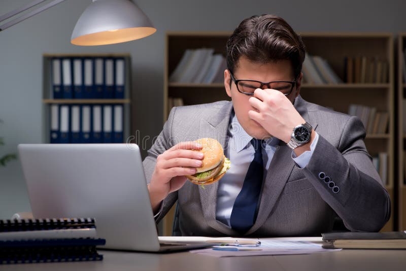 The Businessman Late at Night Eating a Burger Stock Photo - Image of ...