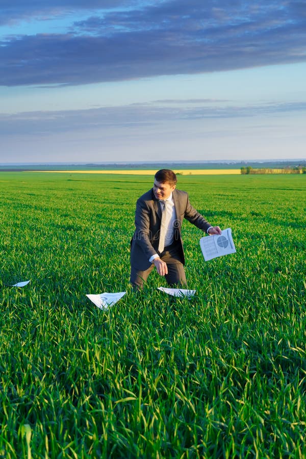 Businessman Lays Out Reports on a Green Grass Field, the Concept of ...