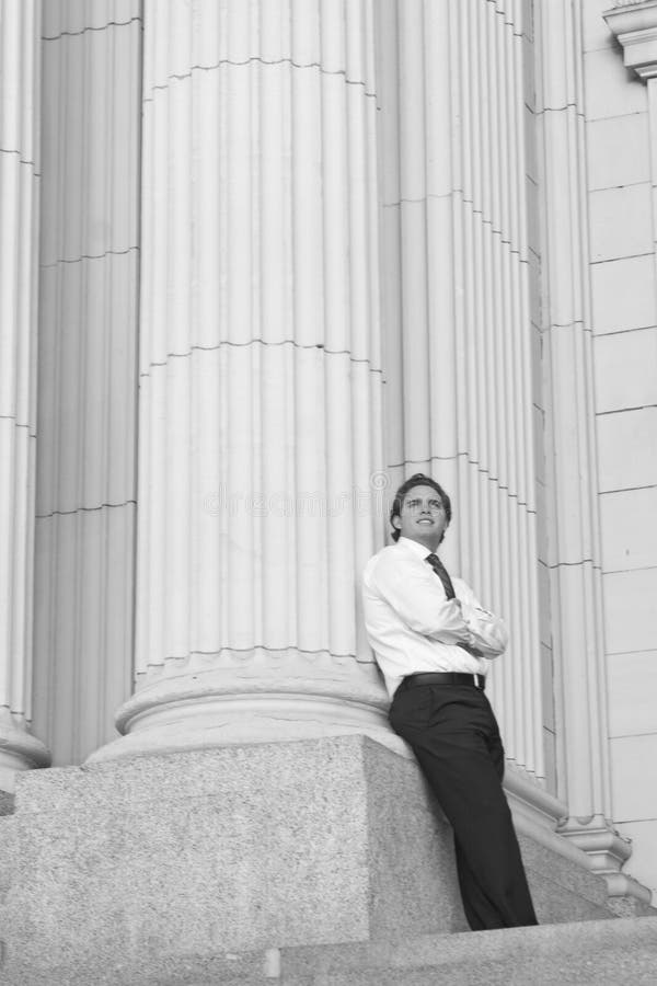 Businessman Leaning Against Column Stock Photo - Image of american ...