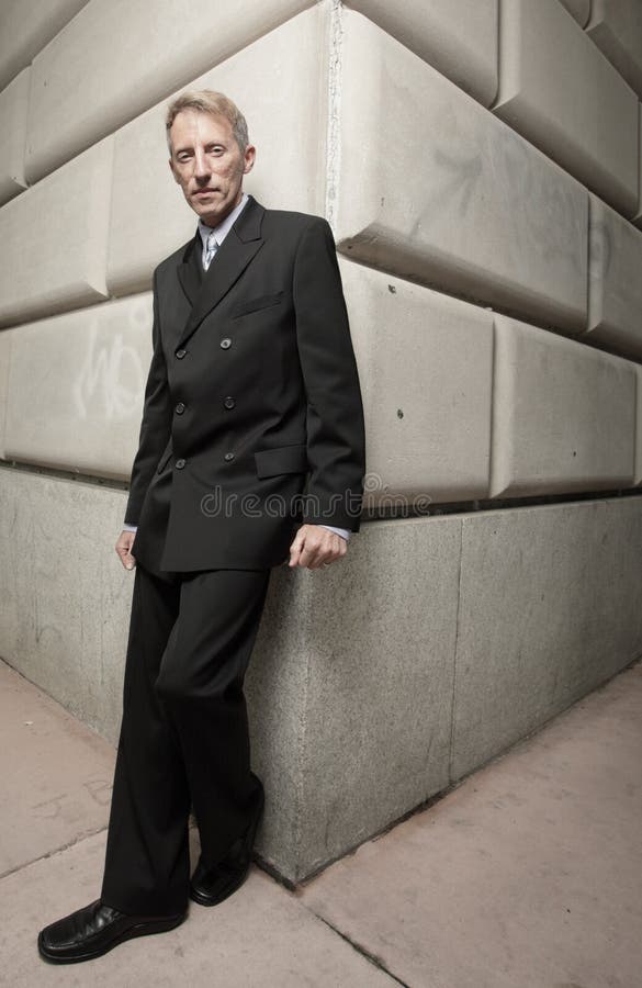 Businessman Leaning on a Building Stock Photo - Image of staring ...