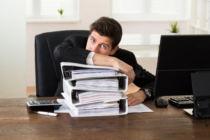 Businessman Leaning on Stack of Folders Stock Photo - Image of paper ...