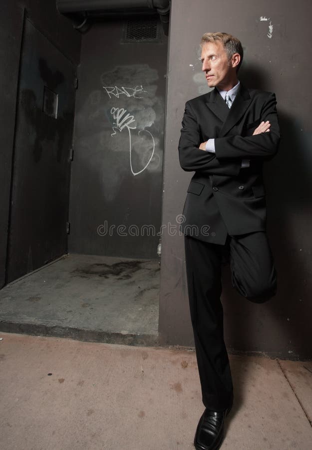Businessman Leaning on a Wall at Night Stock Photo - Image of black ...