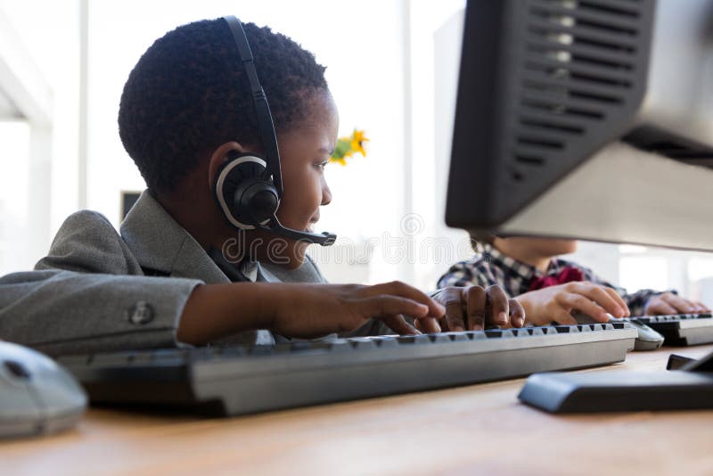 Side View of Businessmen Using Computer while Talking through Headset ...