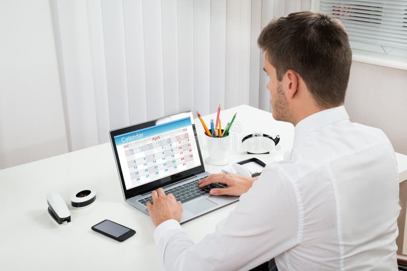 Man with Pen Looking at Calendar Stock Image - Image of career ...