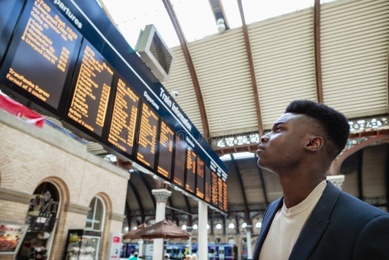 Checking Train Times stock image. Image of black, headshot - 162600763
