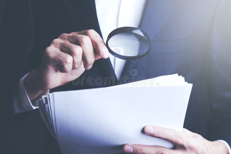 Businessman Looking at Document through Magnifying Glass Stock Image ...