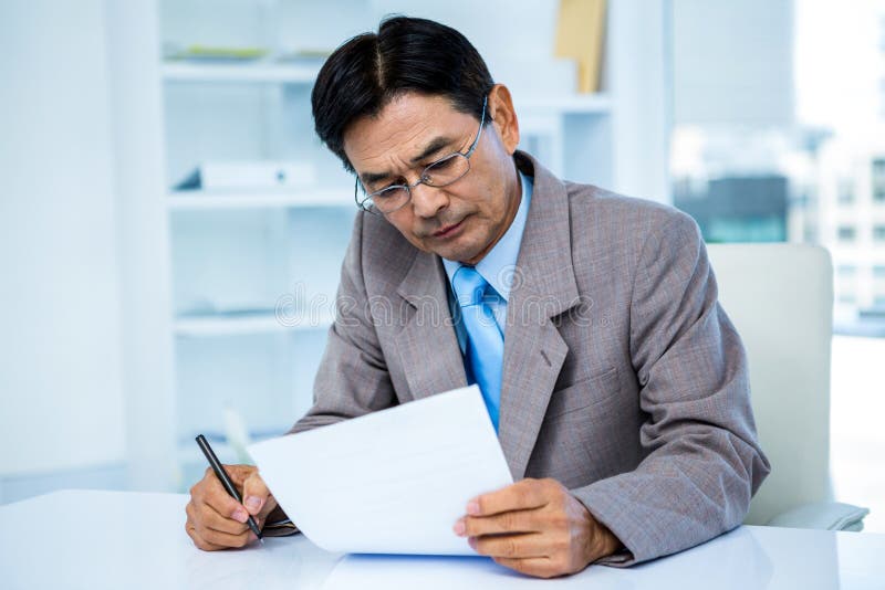 Businessman Looking at Document Stock Image - Image of sophisticated ...