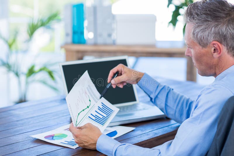 Businessman Looking at Documents with Graphic Stock Photo - Image of ...