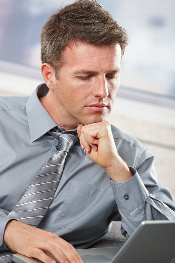 Businessman Looking Down At Computer Stock Photo - Image of fourties ...