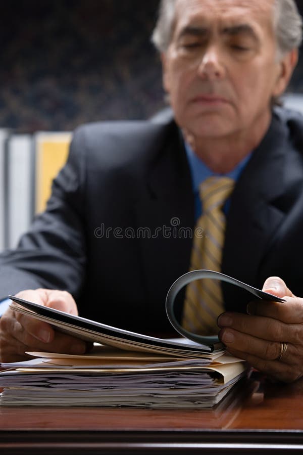Businessman Looking at File Stock Photo - Image of formalwear, indoors ...
