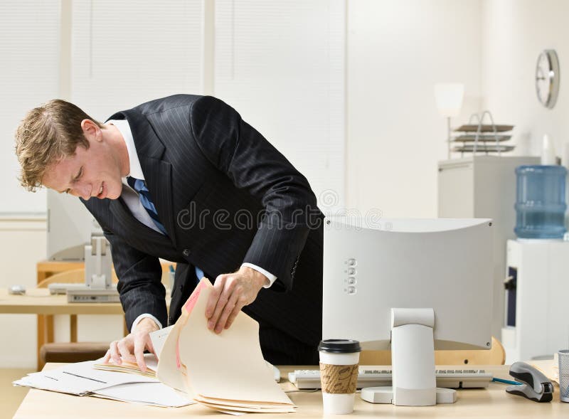 Businessman Looking through File Folders Stock Image - Image of young ...