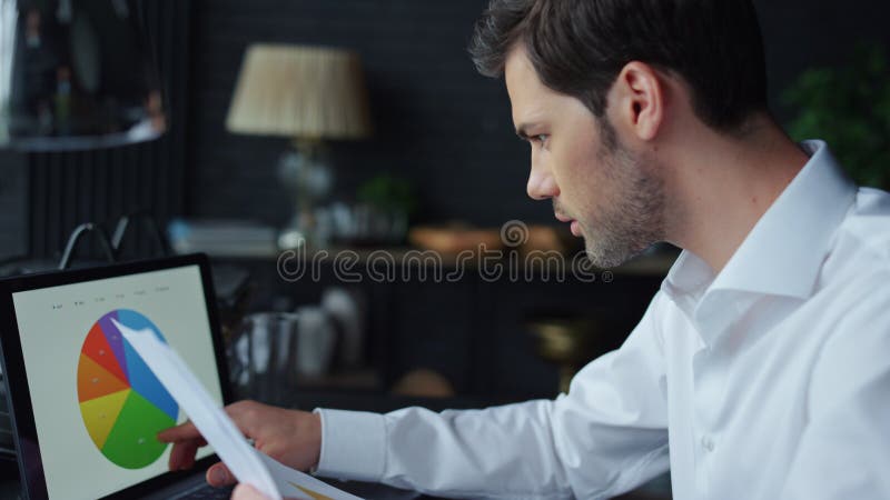 Businessman Looking at Graphs on Laptop Screen at Office. Manager Using ...