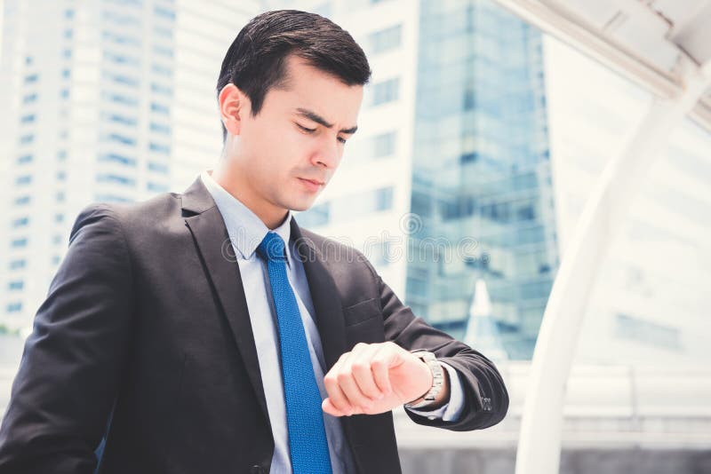 Businessman Looking at His Watch Checking Time Stock Image - Image of ...