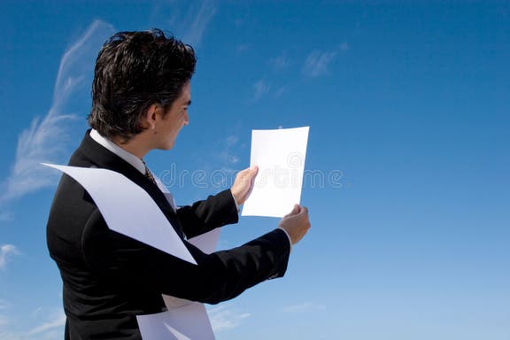 Businessman Looking Over Paperwork Stock Photo - Image of leadership ...