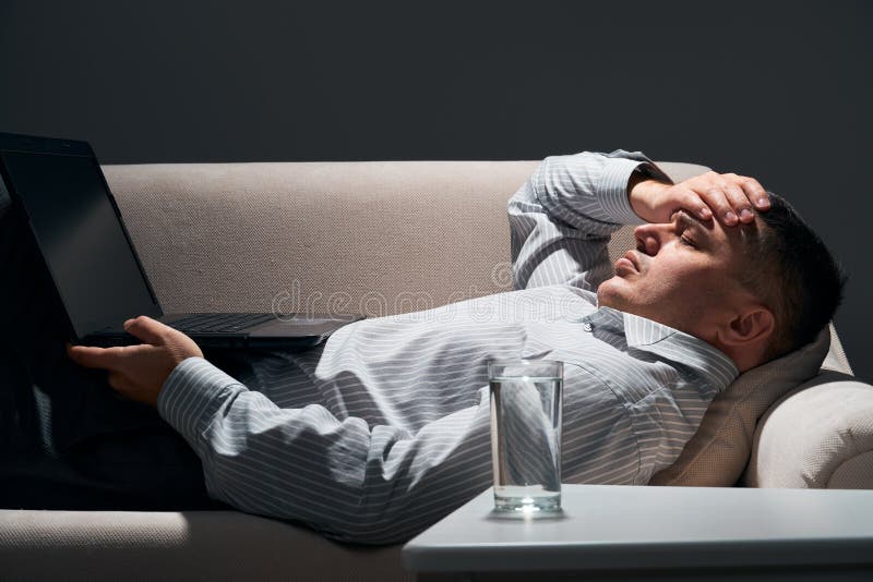 Businessman is Lying on the Sofa with Laptop and Resting Stock Image ...