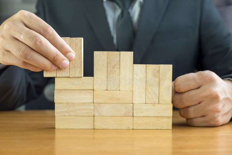Businessman Make a Building with Wood Blocks Stock Photo - Image of ...