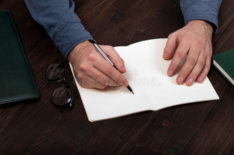 Businessman Makes a Note at Notebook Stock Image - Image of book ...