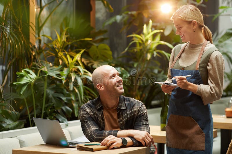 Waiter with client in cafe stock image. Image of businessman - 198924009