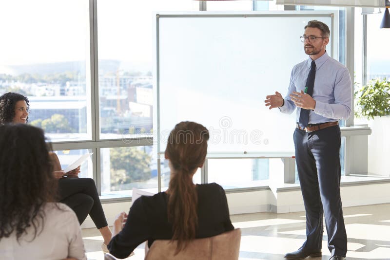 Businessman Making Presentation To Colleagues in Office Stock Photo ...