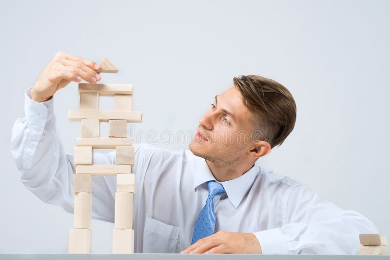 Businessman making tower stock image. Image of creation - 61365029