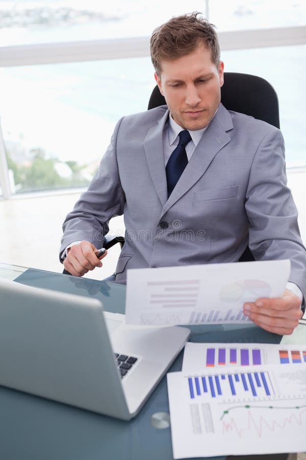 Businessman with Market Research Results Leaning Back Stock Photo ...