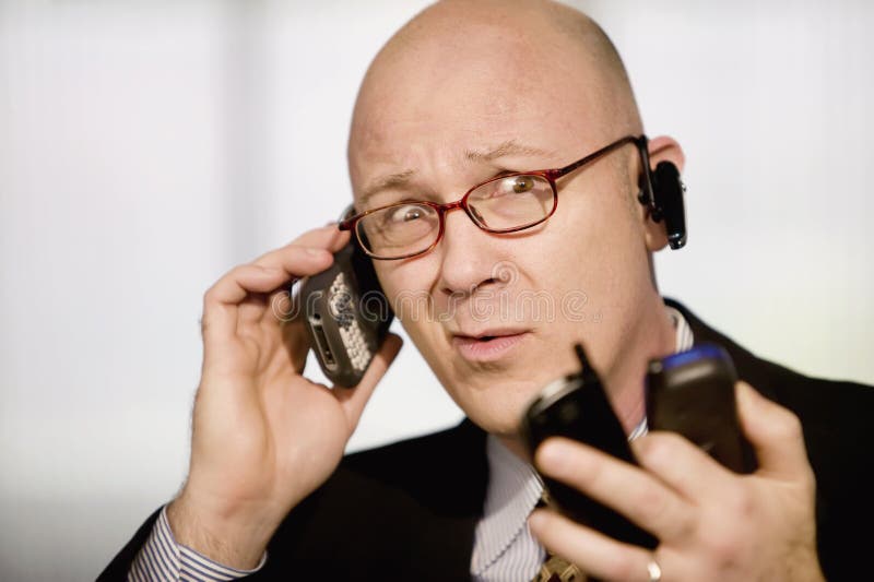 Businessman with Multiple Cell Phones Stock Image - Image of boss ...
