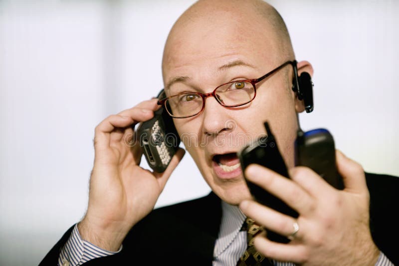 Businessman with Multiple Cell Phones Stock Image - Image of boss, professional: 4611981