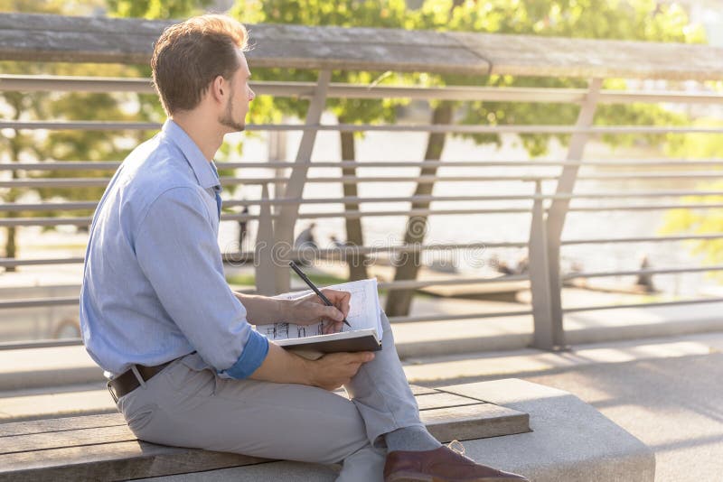 Businessman with Notepad on Bench Stock Image - Image of concentration ...