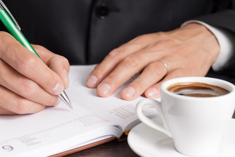 Businessman Notes His Idea To Diary Stock Photo - Image of person ...