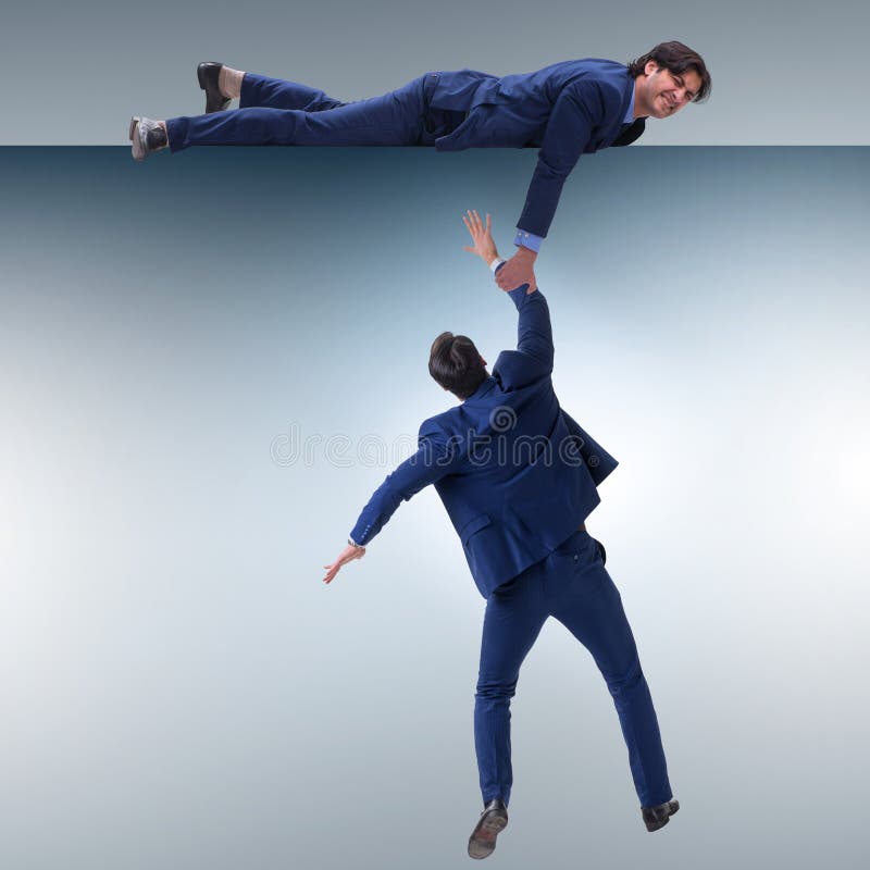 The Businessman Offering Helping Hand To Falling Colleague Stock Photo ...