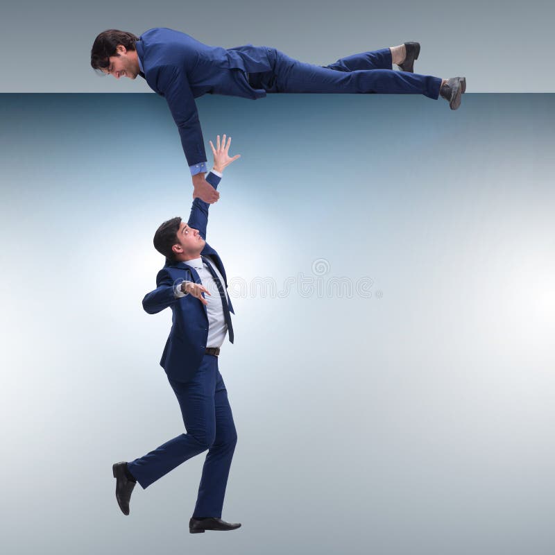 The Businessman Offering Helping Hand To Falling Colleague Stock ...