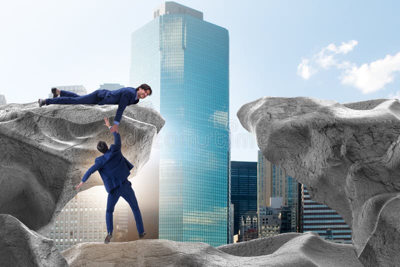 The Businessman Offering Helping Hand To Falling Colleague Stock Photo ...