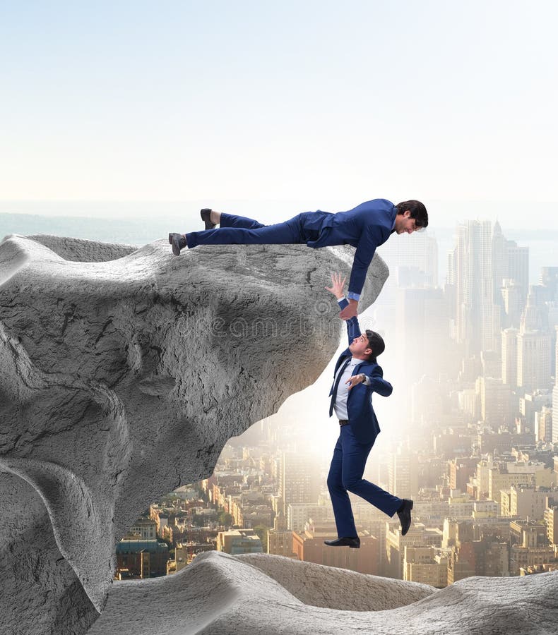 Businessman Offering Helping Hand To Falling Colleague Stock Photo ...