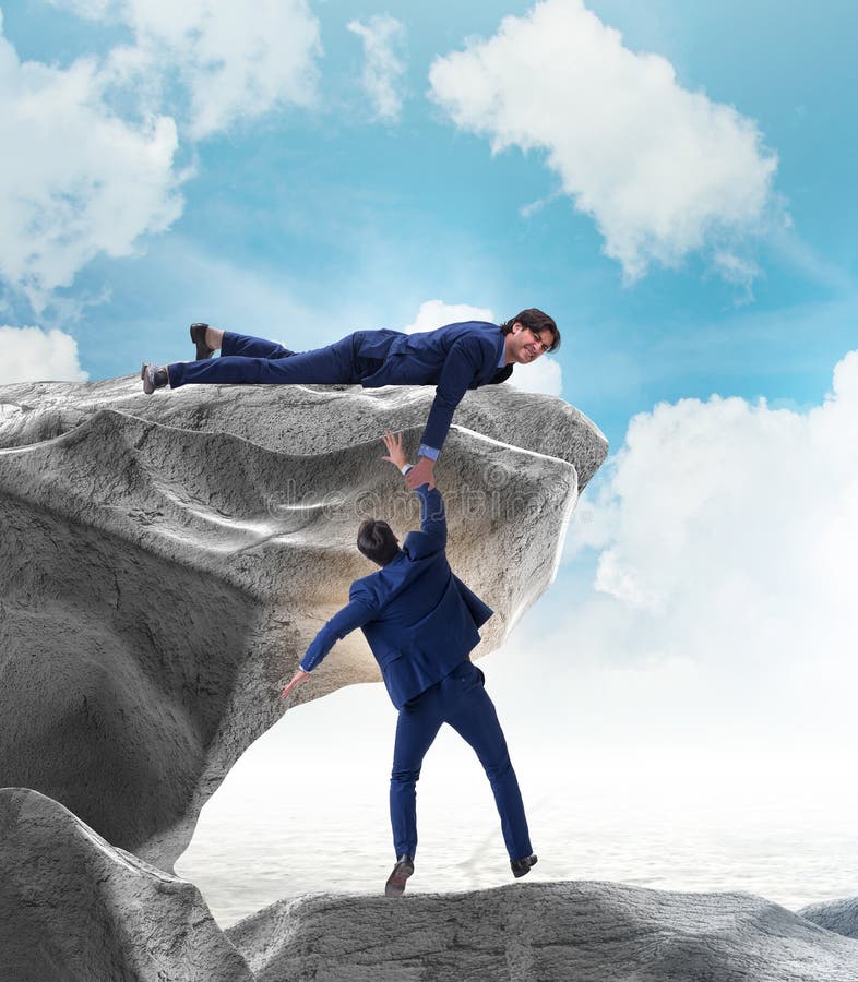 Businessman Offering Helping Hand To Falling Colleague Stock Photo ...