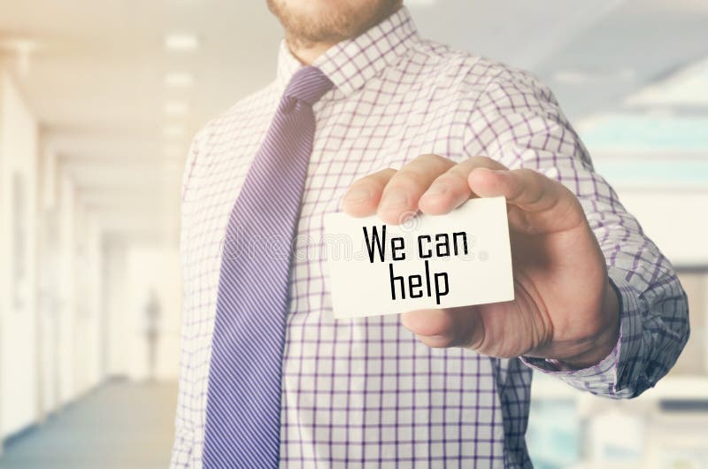 Businessman in Office Showing Card with Text: we Can Help Stock Photo ...