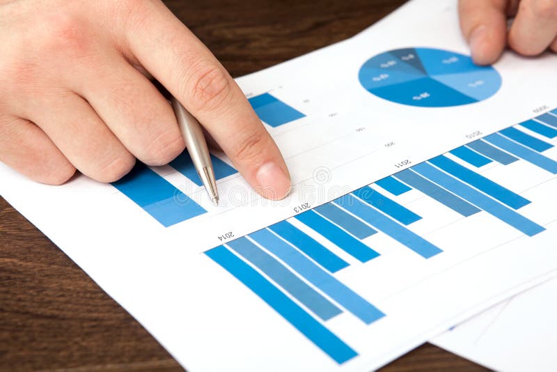 Businessman in the Office of the Table Points To the Graphics Stock ...