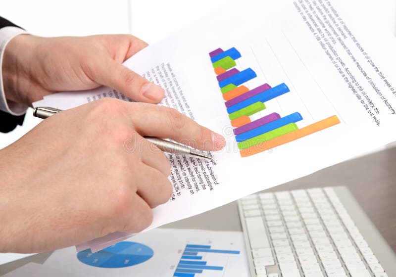 Businessman in the Office of the Table Points To the Graphics Stock ...