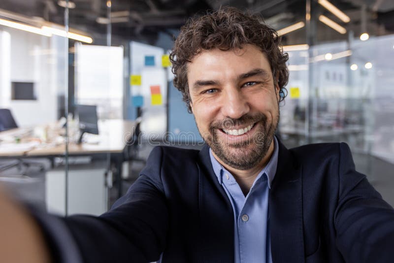 Friendly Businessman in Office during Video Call, Smiling and Looking ...