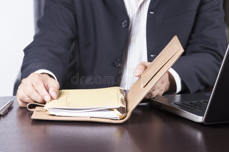 Businessman Opening His Notebook Stock Photo - Image of document, desk ...
