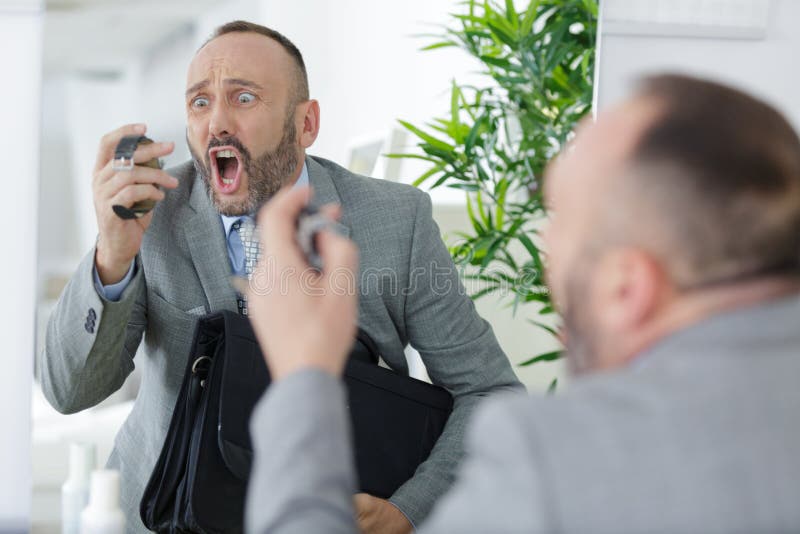 Emotional Businessman Shouting with Megaphone at Frightened Female ...