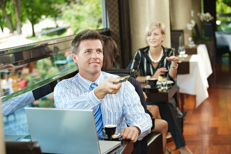 Businessman paying in cafe stock photo. Image of fine - 11161568