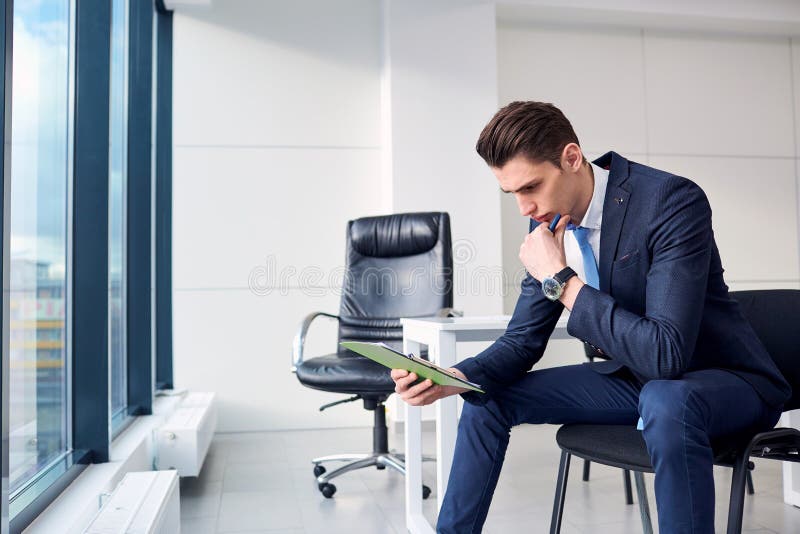 Businessman with Pen in Hand Reading, Thinking Over Contract Pap Stock ...