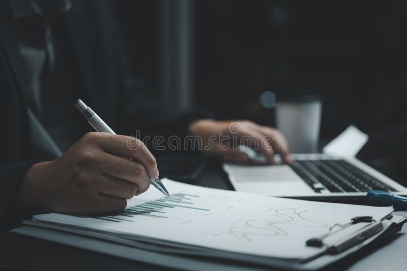 Businessman Pen Pointing Graph and Chart Report and Checking ...